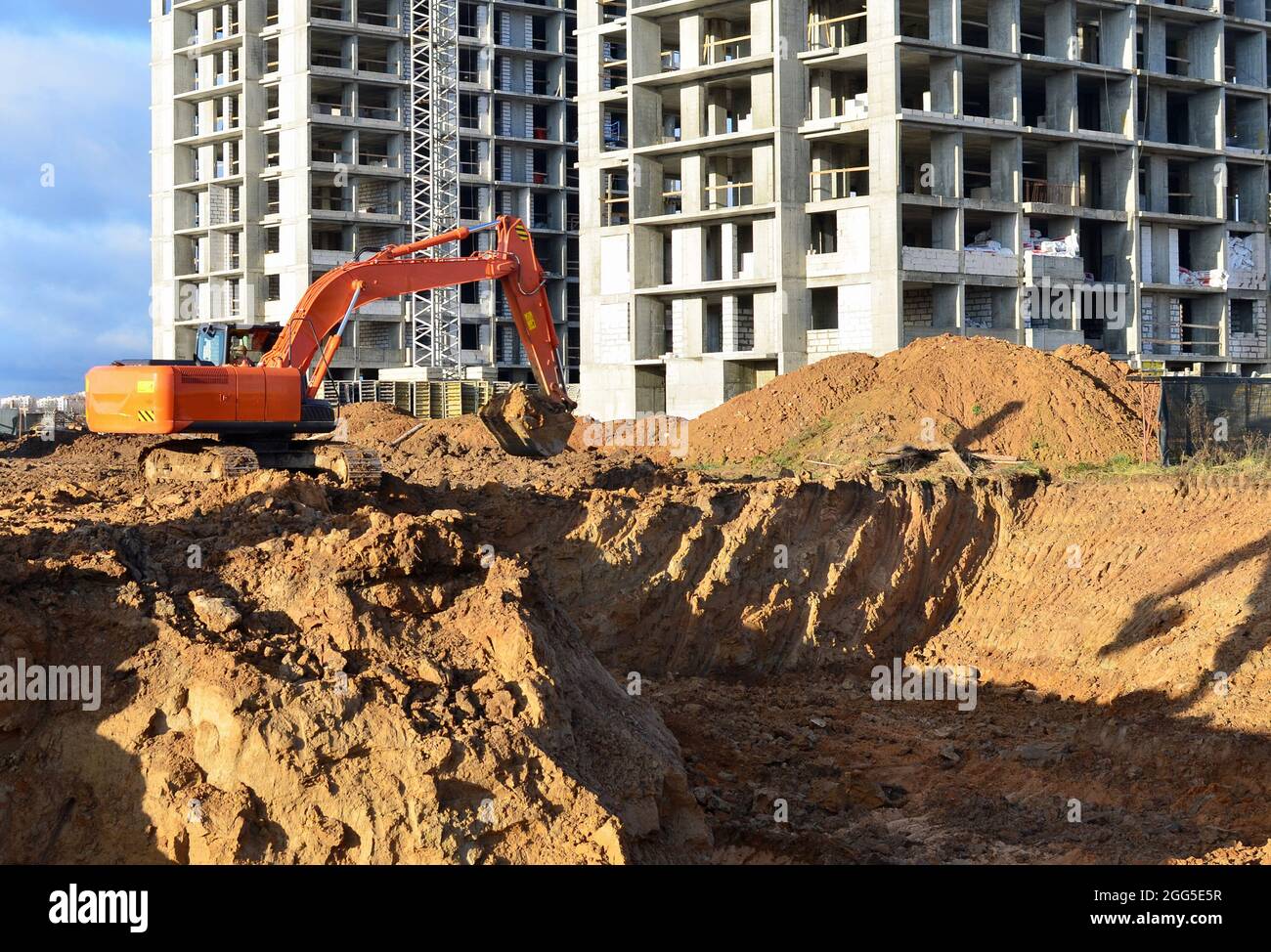 Excavator digging foundation at construction site. Heavy machinery for ...