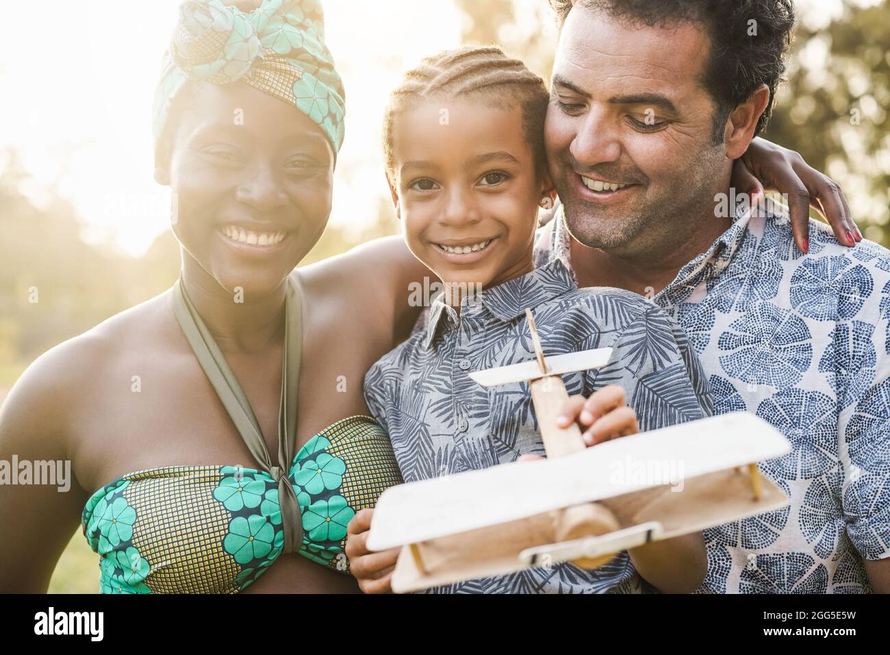 Multiracial family having fun outdoor in city park playing with wood ...