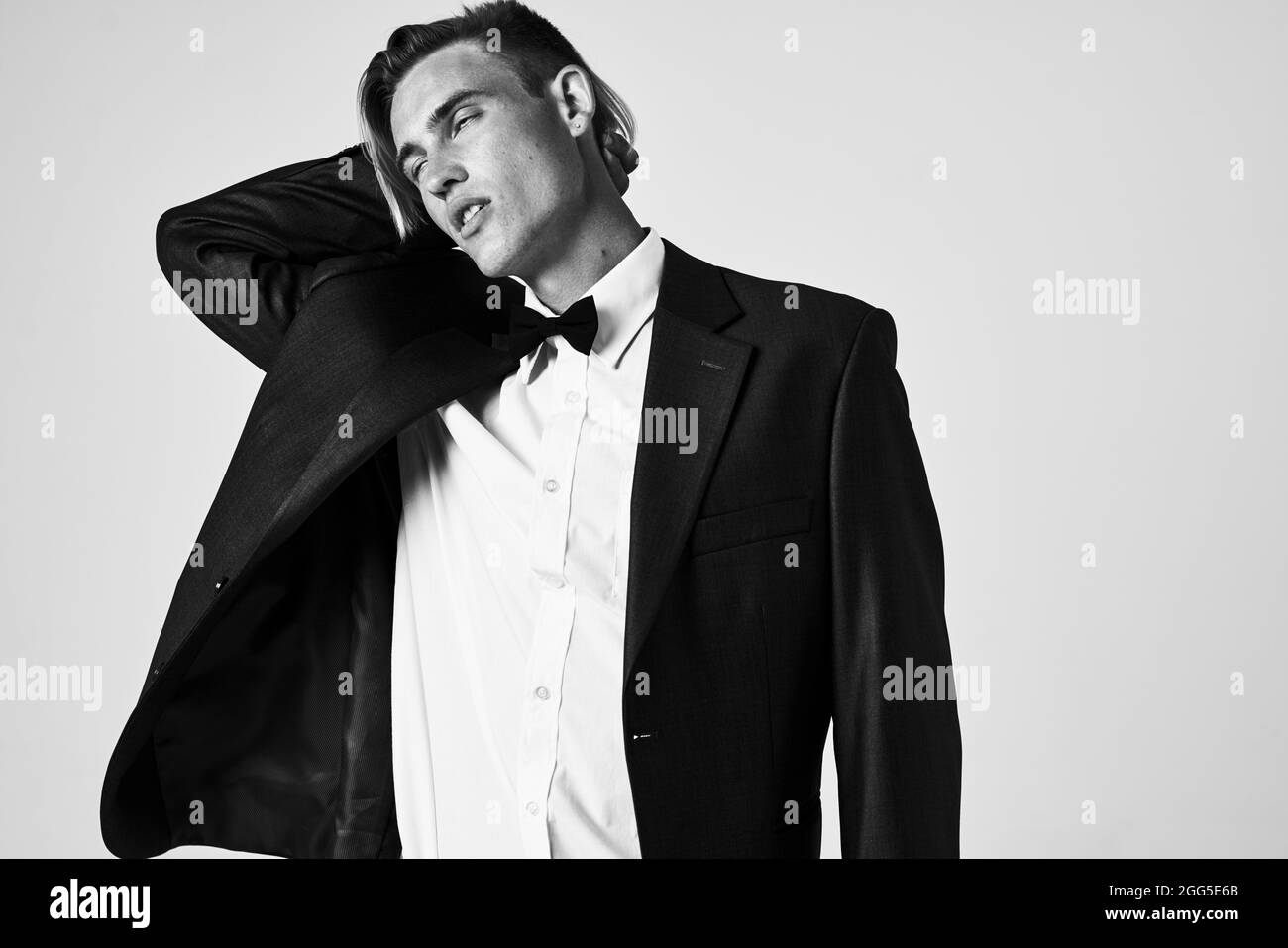 handsome man in suit black jacket bow tie light background Stock Photo ...