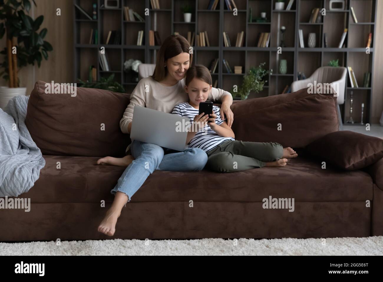 Addicted to modern tech happy family using gadgets Stock Photo - Alamy