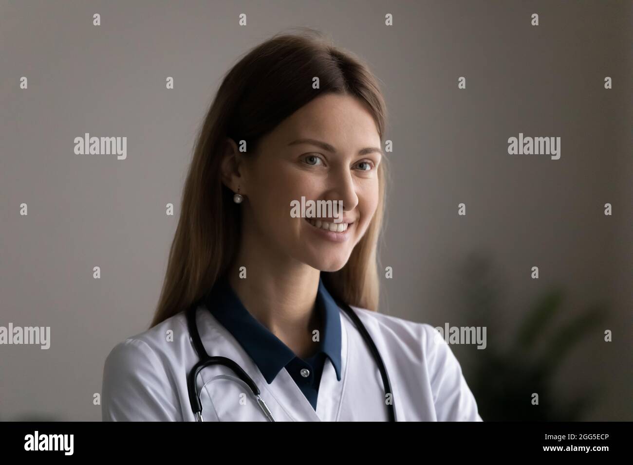 Head shot portrait of smiling dreamy female doctor Stock Photo - Alamy