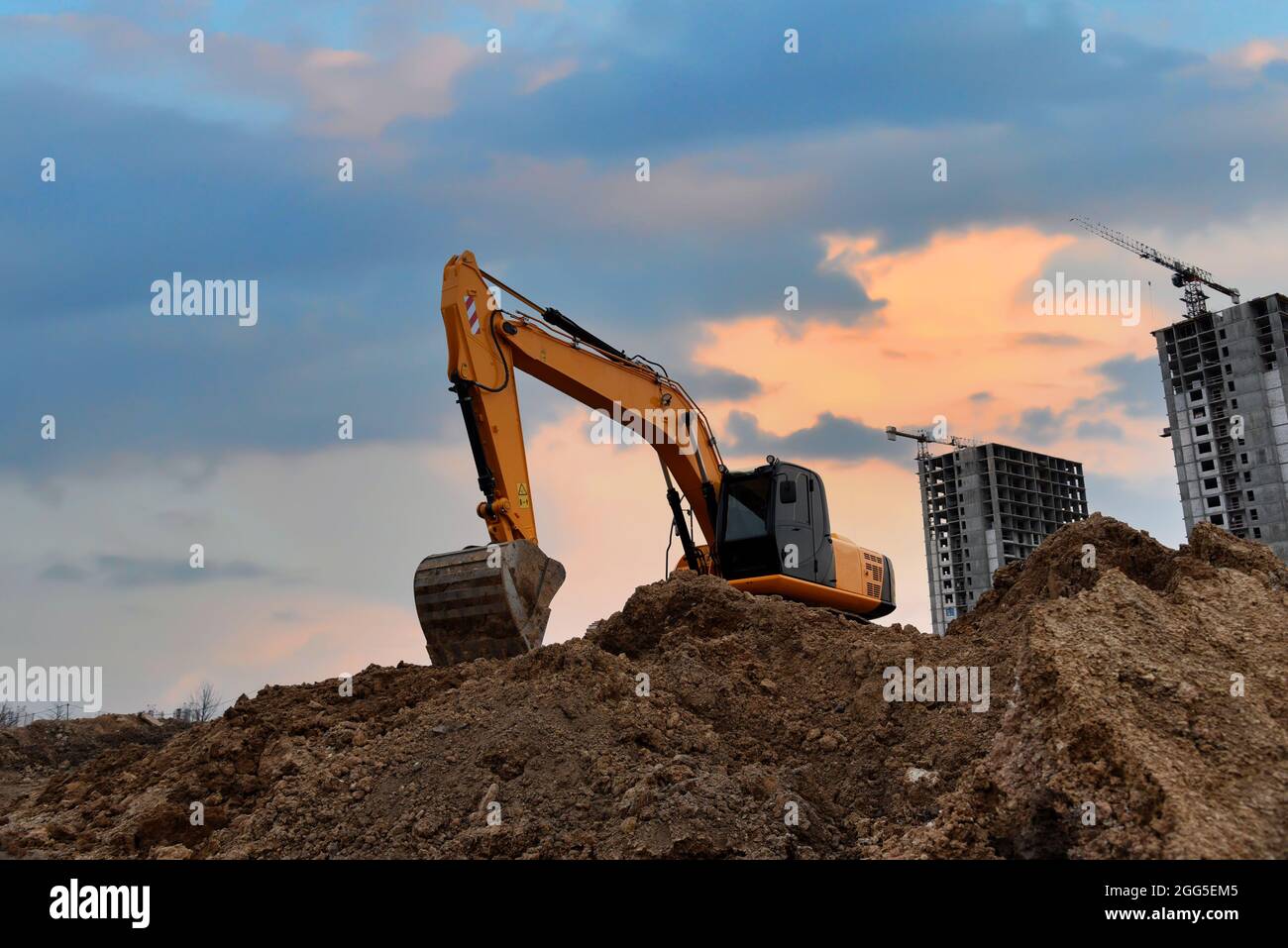 Excavator digging foundation at construction site. Heavy machinery for ...
