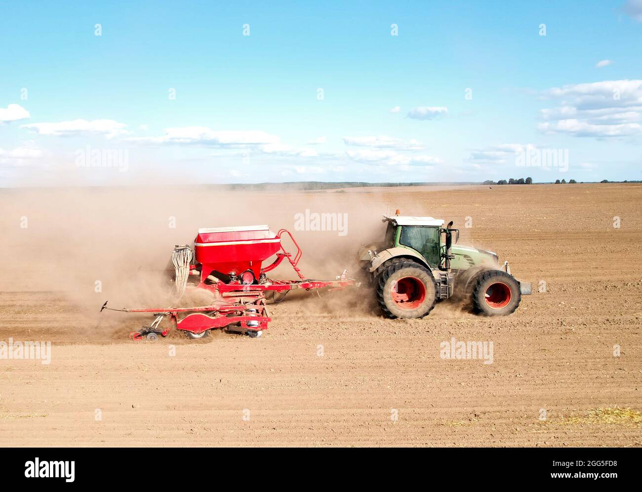 Agricultural tractor on cultivating field for sowing seeds. Farming and ...