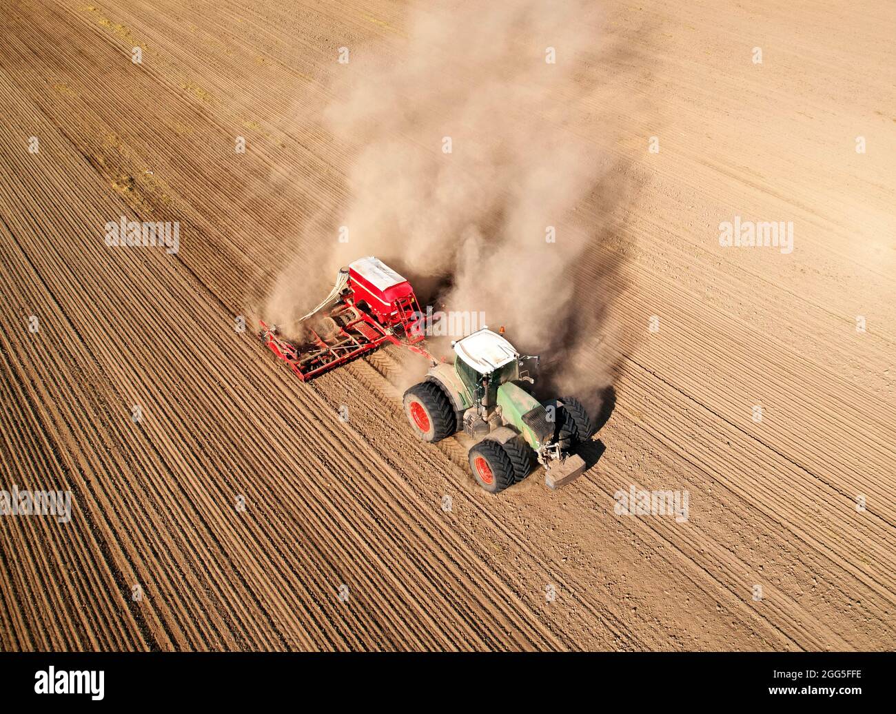 Agricultural tractor on cultivating field for sowing seeds. Farming and ...