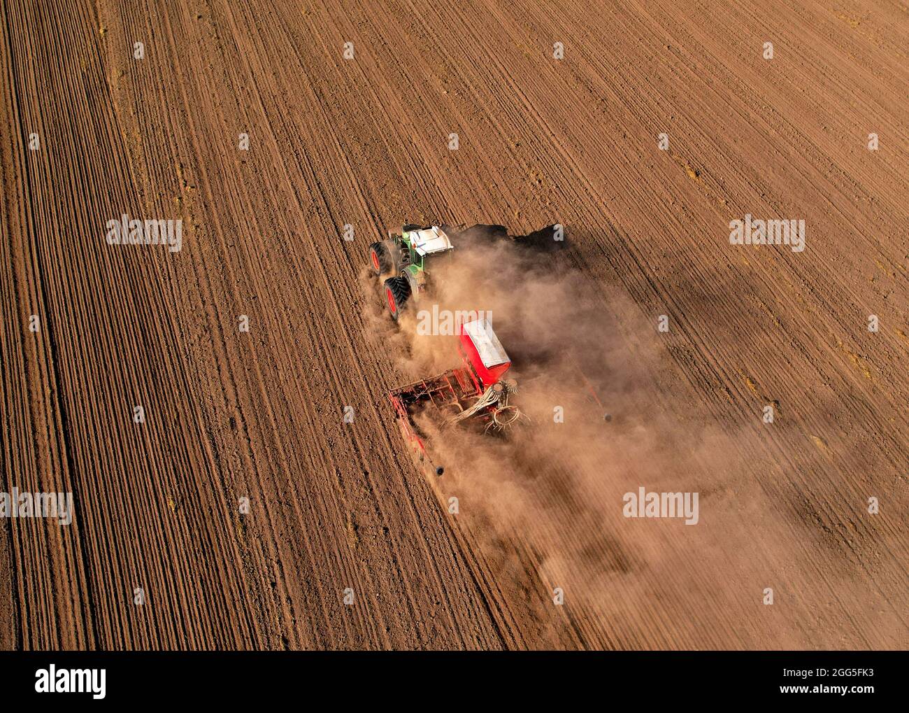 Agricultural tractor on cultivating field for sowing seeds. Farming and ...