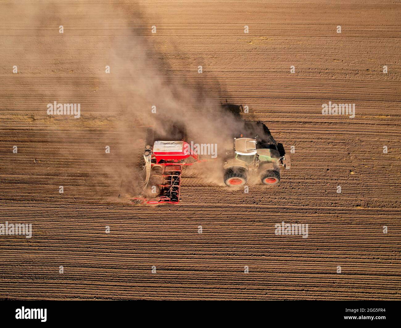 Agricultural tractor on cultivating field for sowing seeds. Farming and ...