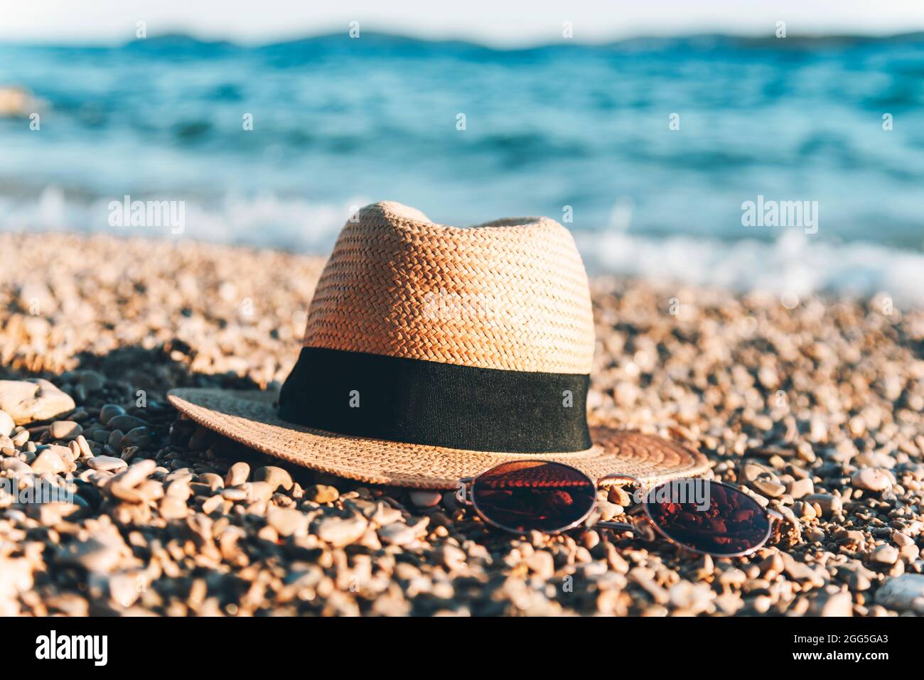 Sunglasses and straw hat on the beach. Summer vacation concept Stock ...