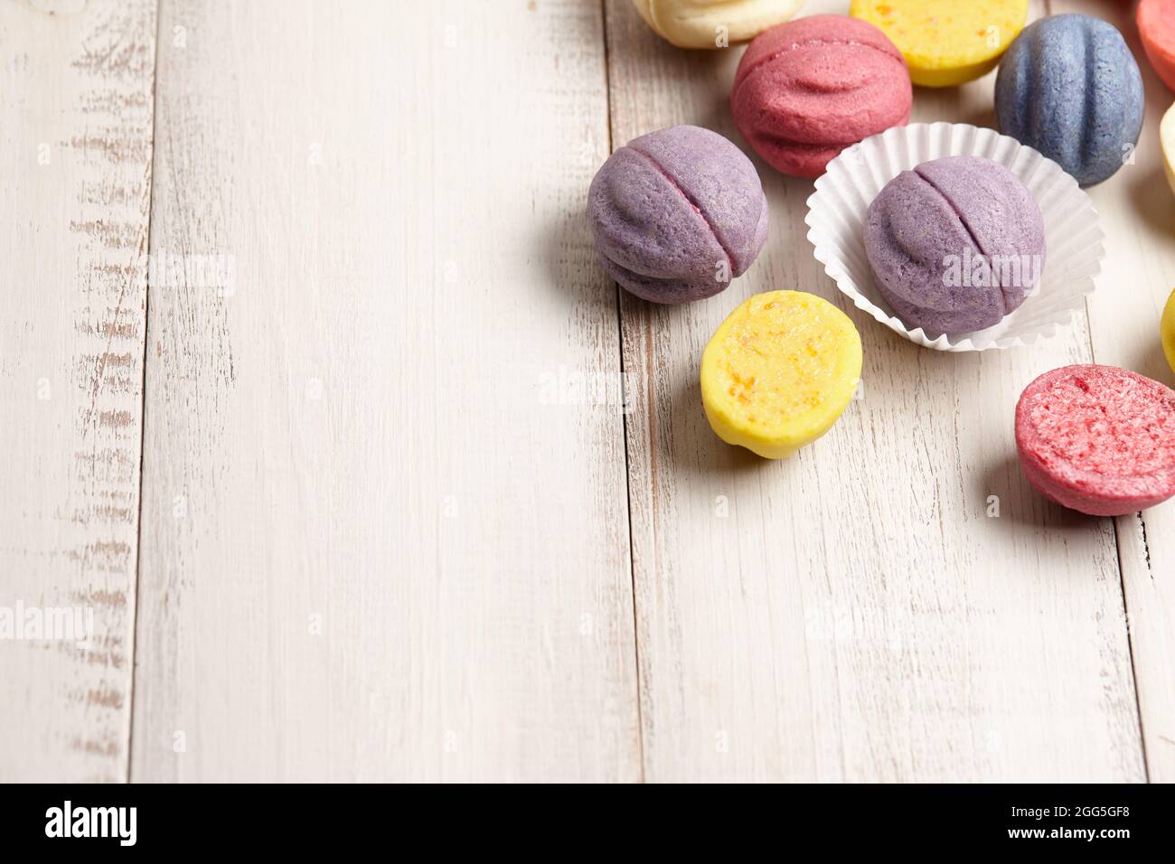 Colorful shortbread desserts on white wooden background Stock Photo - Alamy
