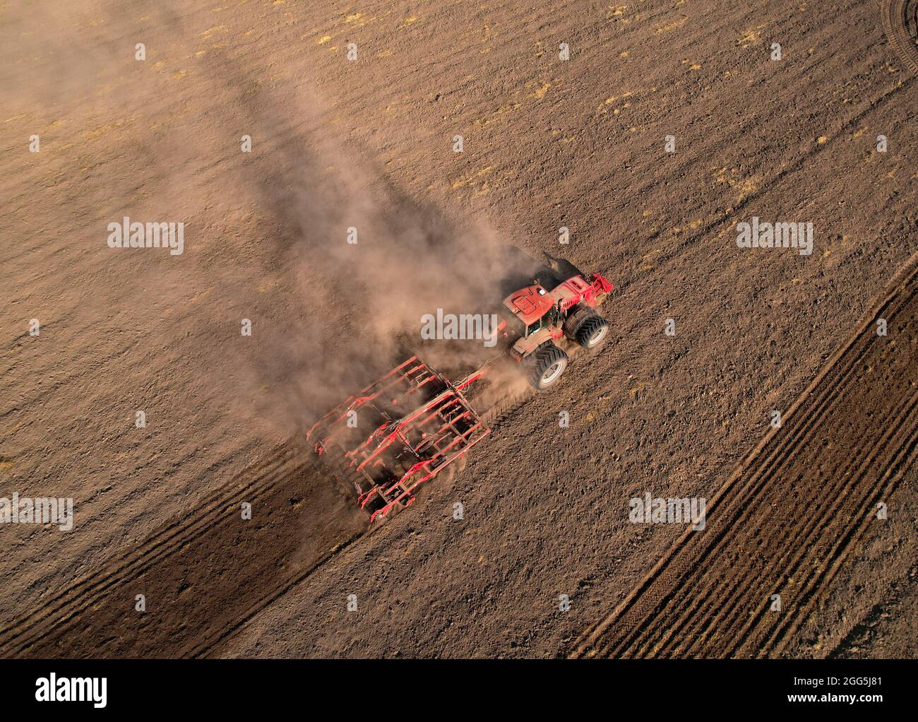 Agricultural tractor on cultivating field for sowing seeds. Farming and ...