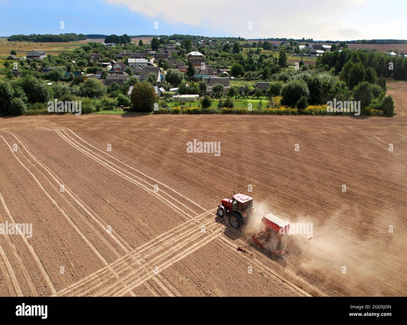 Agricultural tractor on cultivating field for sowing seeds. Farming and ...