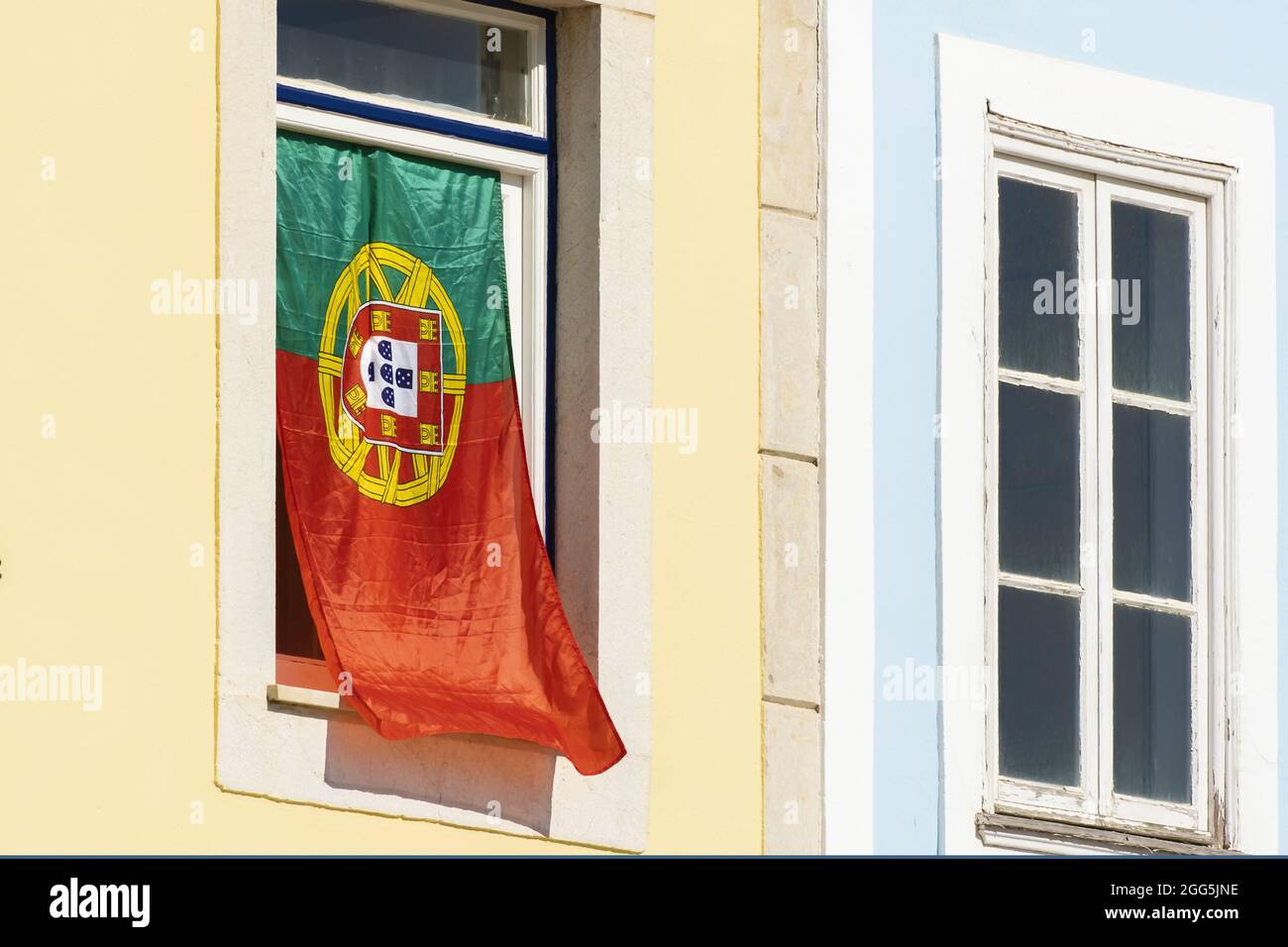 beautiful flag of portugal hanging on a window of a house in Lagos ...