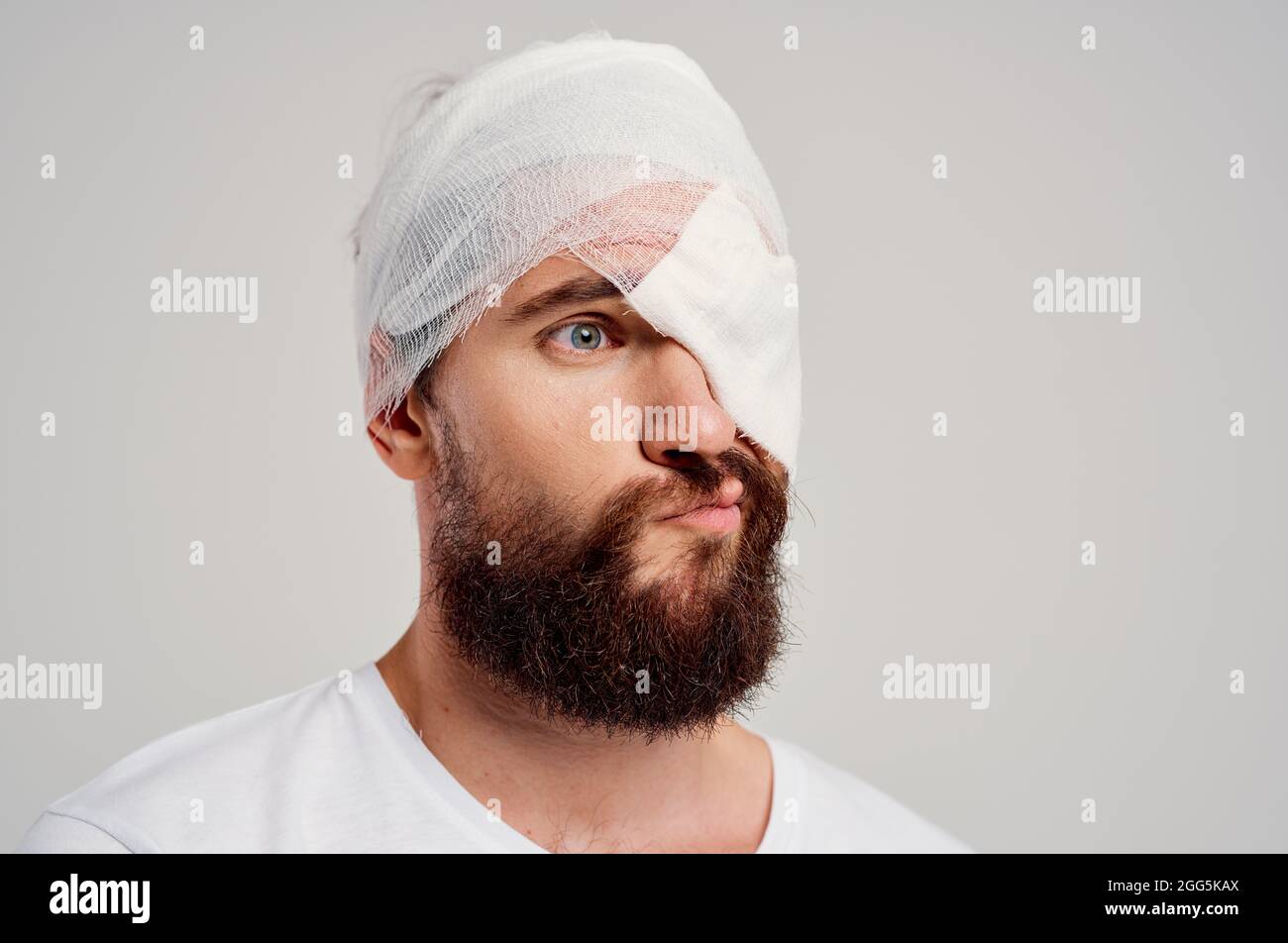 Man with a bandaged head and an eye blood isolated background Stock ...