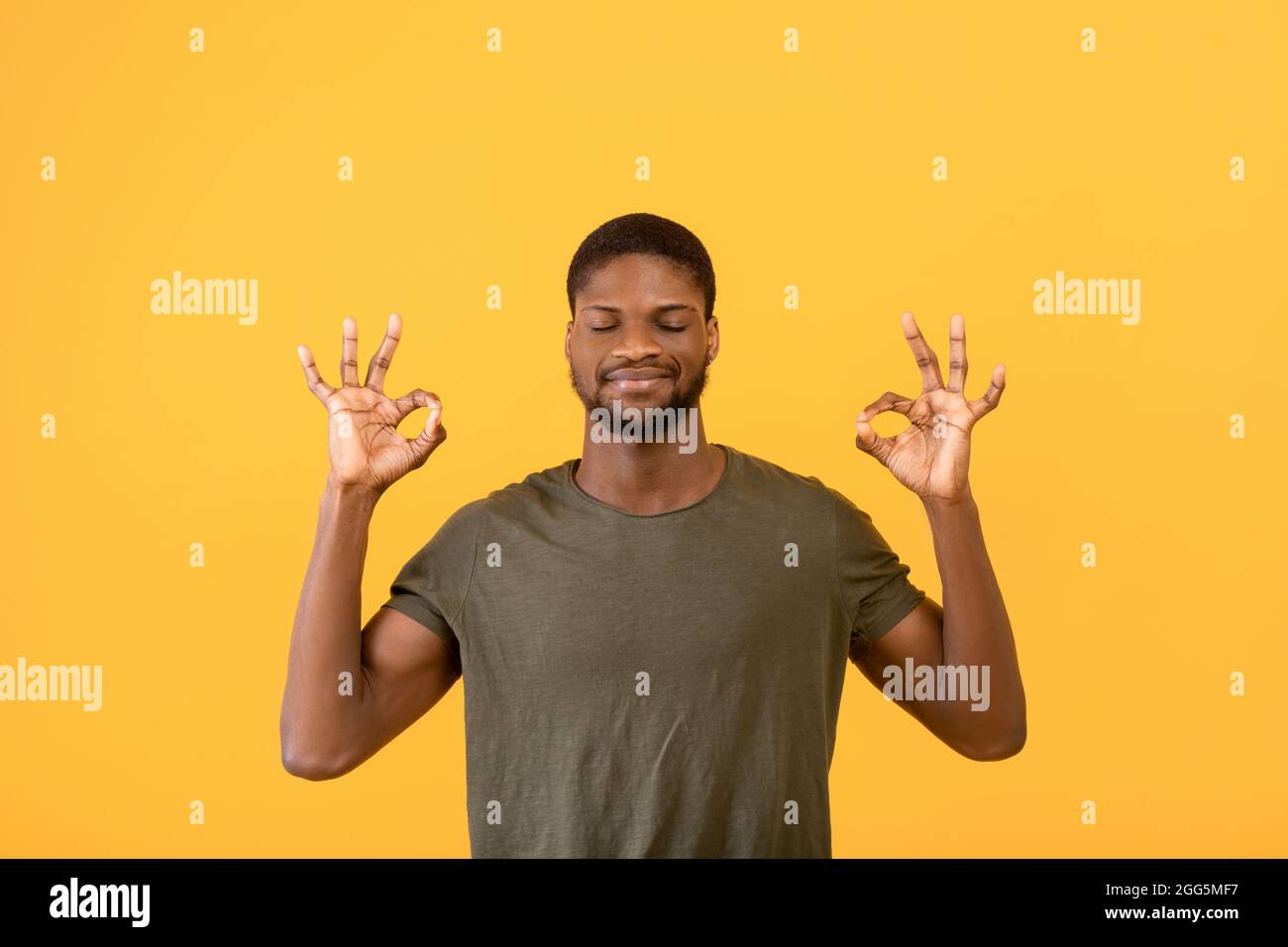 Stress relief concept. Young black man meditating with closed eyes ...