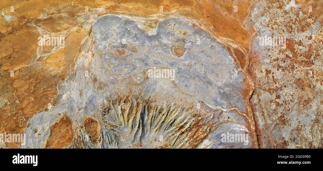 Monster shaped grey stain over rusty orange background, natural texture ...