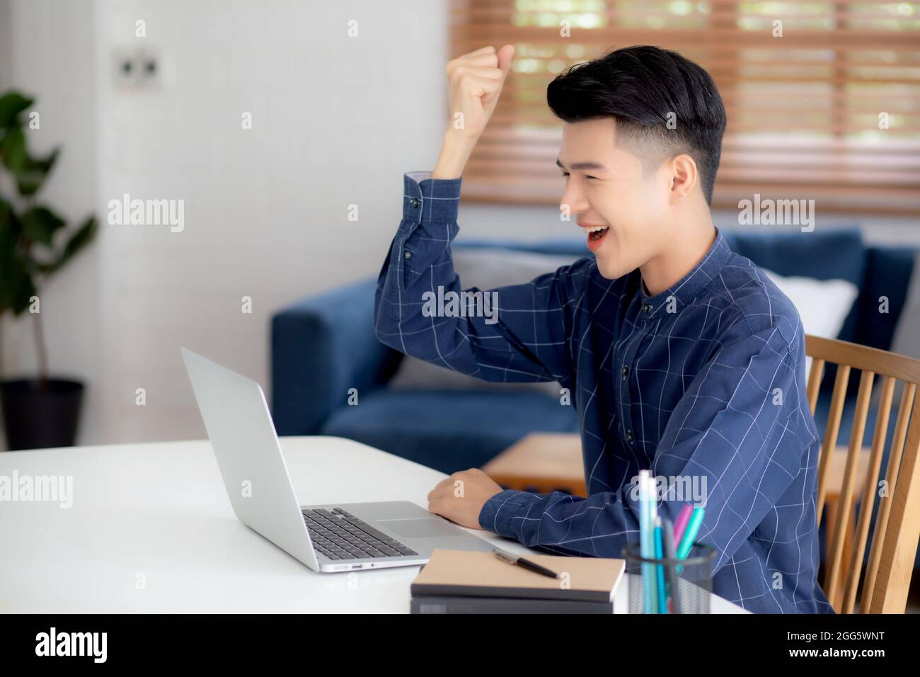 Happy young businessman work on laptop computer finish with excited and ...