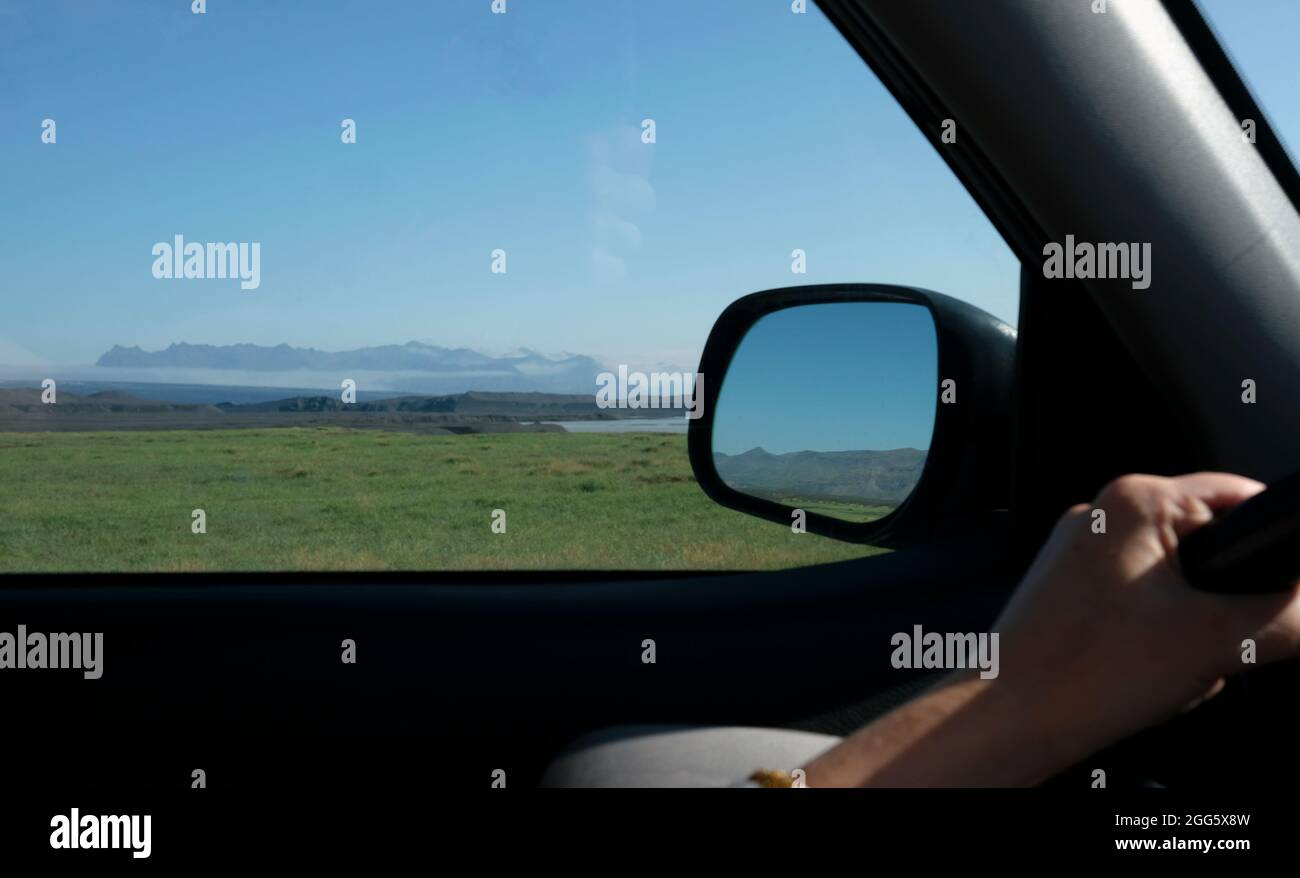 Road trip through Iceland with the landscape seen through the window ...