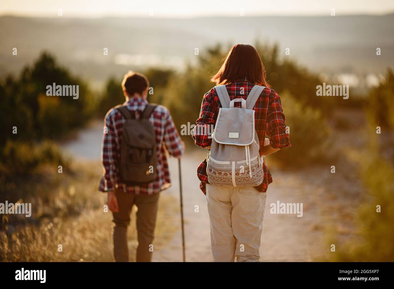 Portrait of happy young couple having fun on their hiking trip ...