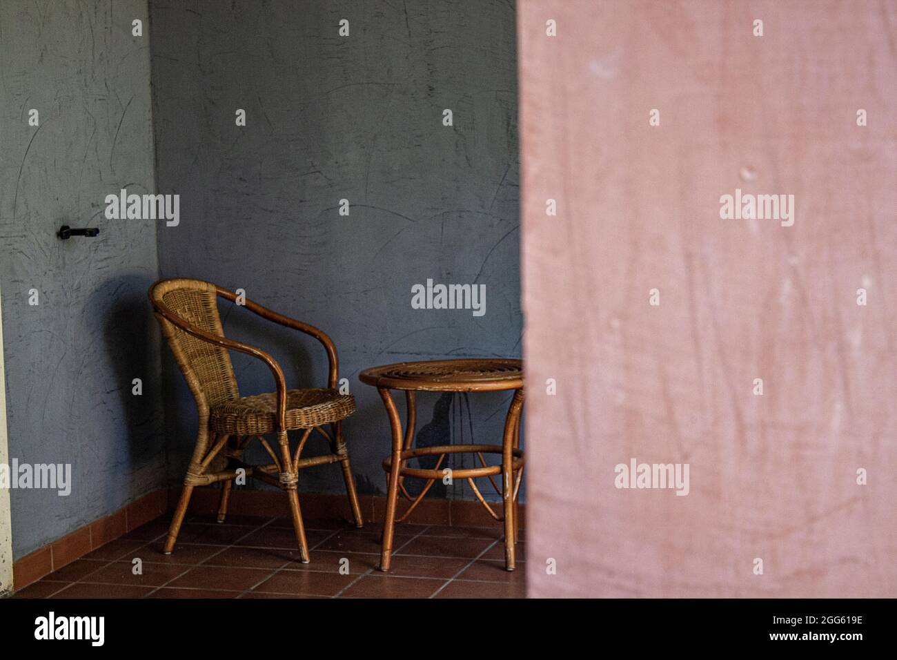 Vintage wooden chair and coffee table in a porch - veranda framed by a ...