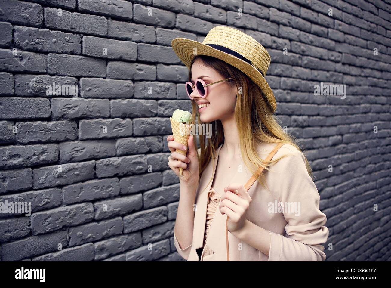 cheerful woman wearing sunglasses brick wall walk ice cream Stock Photo ...