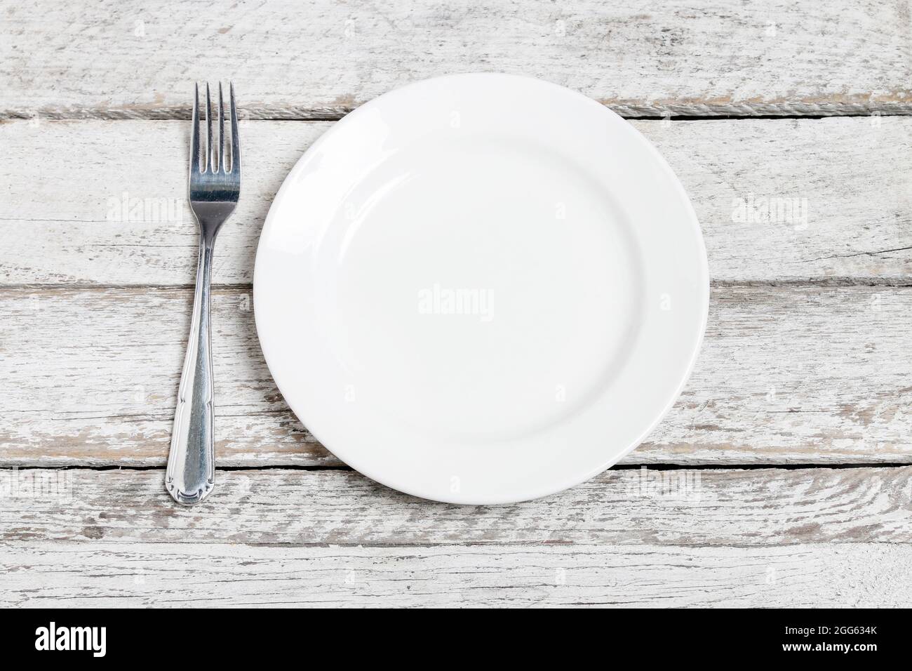 Top view empty plate on rustic wooden table. Idea of hunger Stock Photo ...