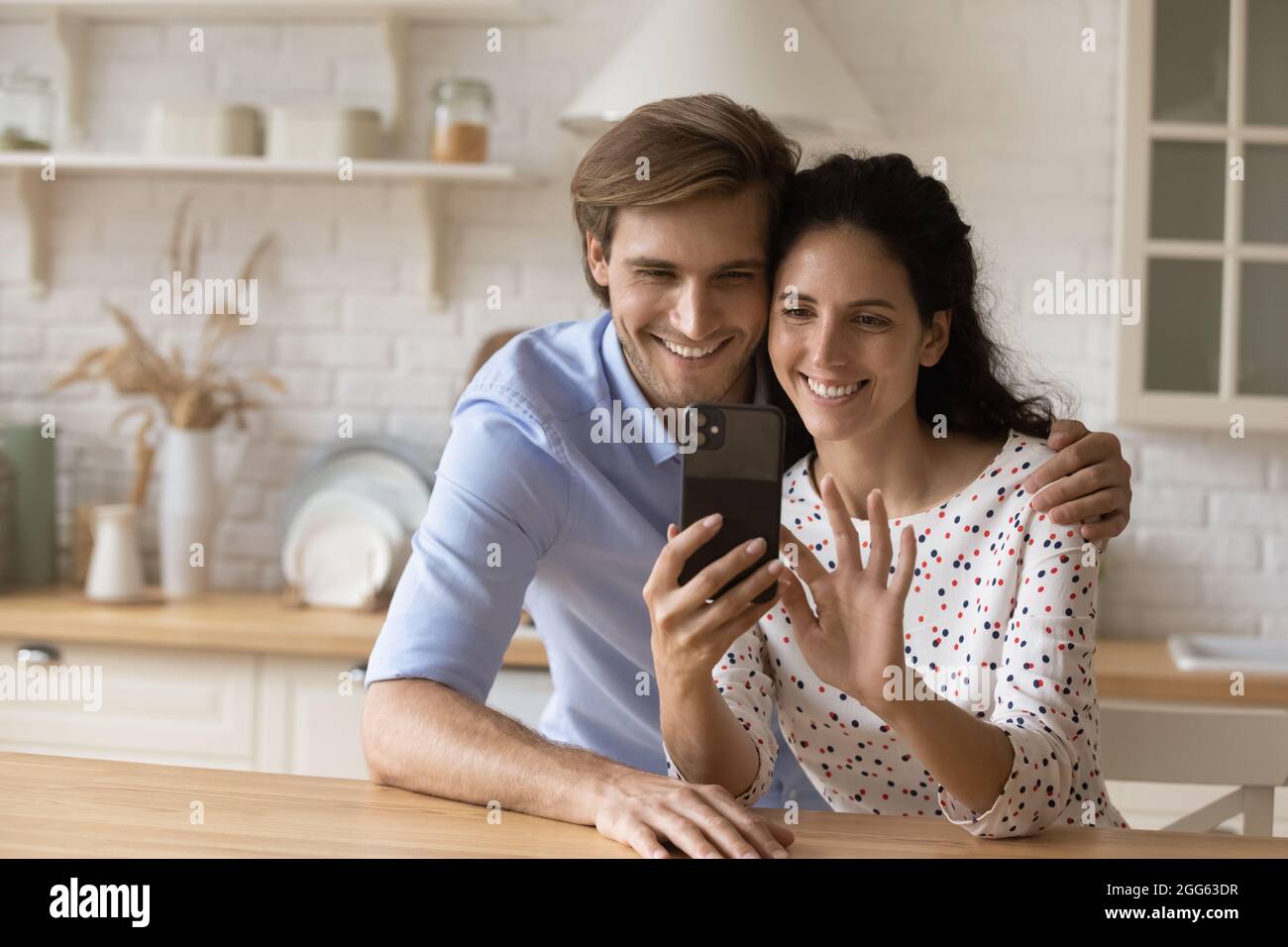 Happy bonding millennial family couple using smartphone Stock Photo - Alamy