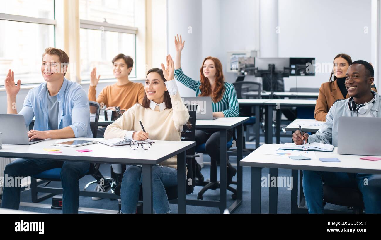 Portrait of diverse people raising hands at seminar Stock Photo - Alamy