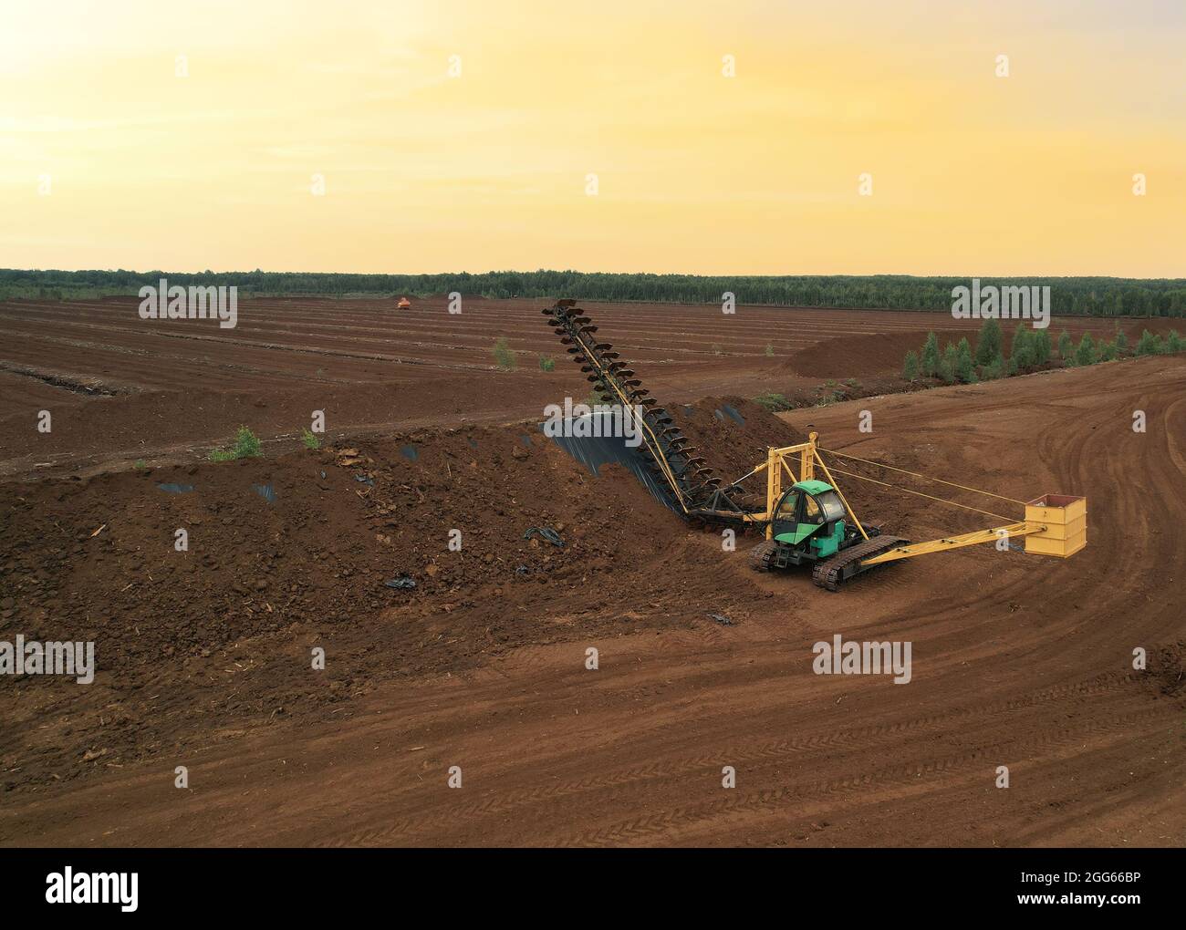 Peat extraction site. Harvester at collecting peat on peatlands. Mining ...
