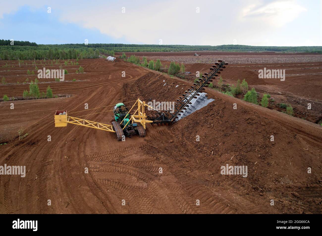 Peat extraction site. Harvester at collecting peat on peatlands. Mining ...