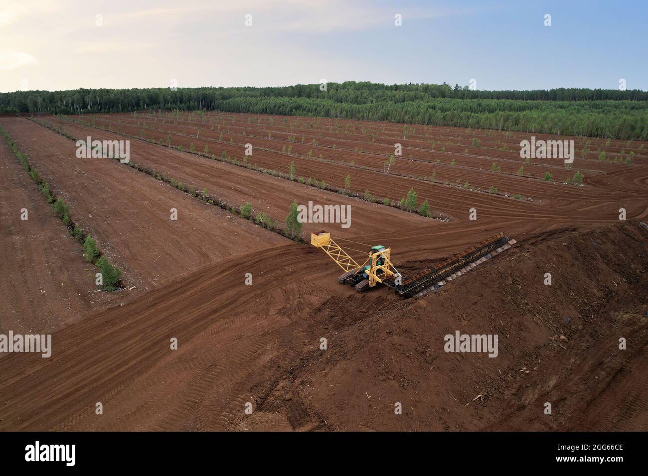 Peat extraction site. Harvester at collecting peat on peatlands. Mining ...