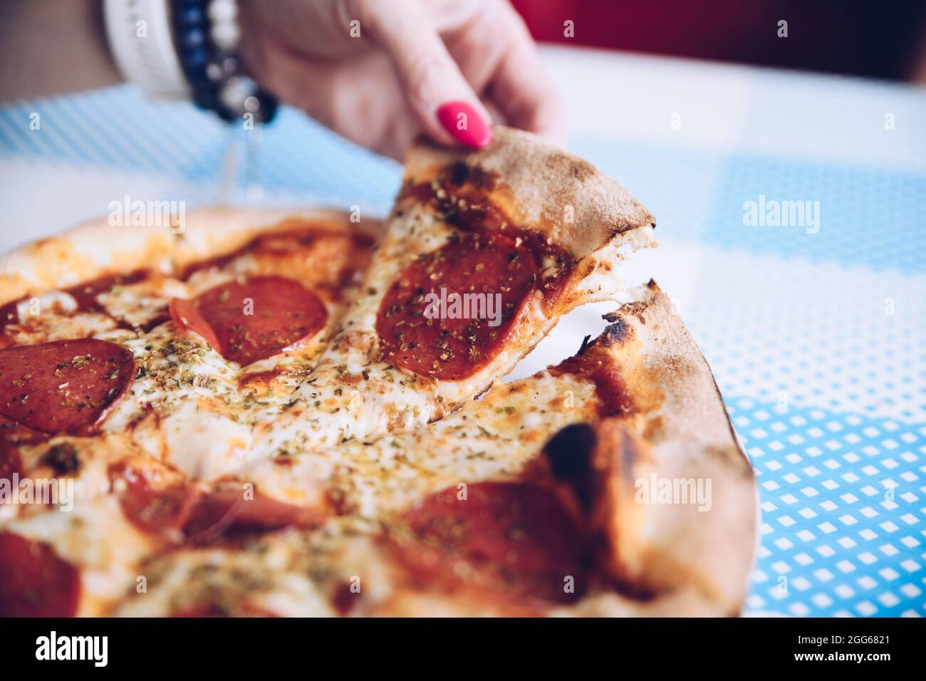Hand taking pizza slice. Hot italian pepperoni Stock Photo - Alamy