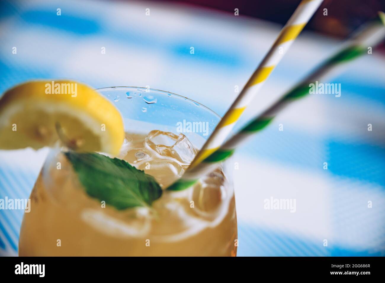 Glass of lemonade with ice cubes and fruit Stock Photo - Alamy