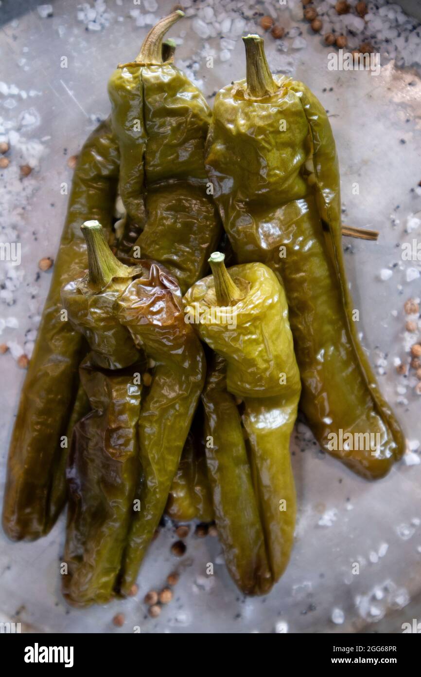 Presentation of a bunch of baked green peppers flavored with juniper ...