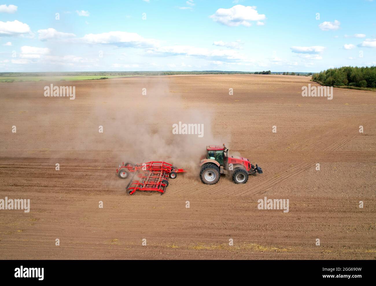 Agricultural tractor on cultivating field for sowing seeds. Farming and ...