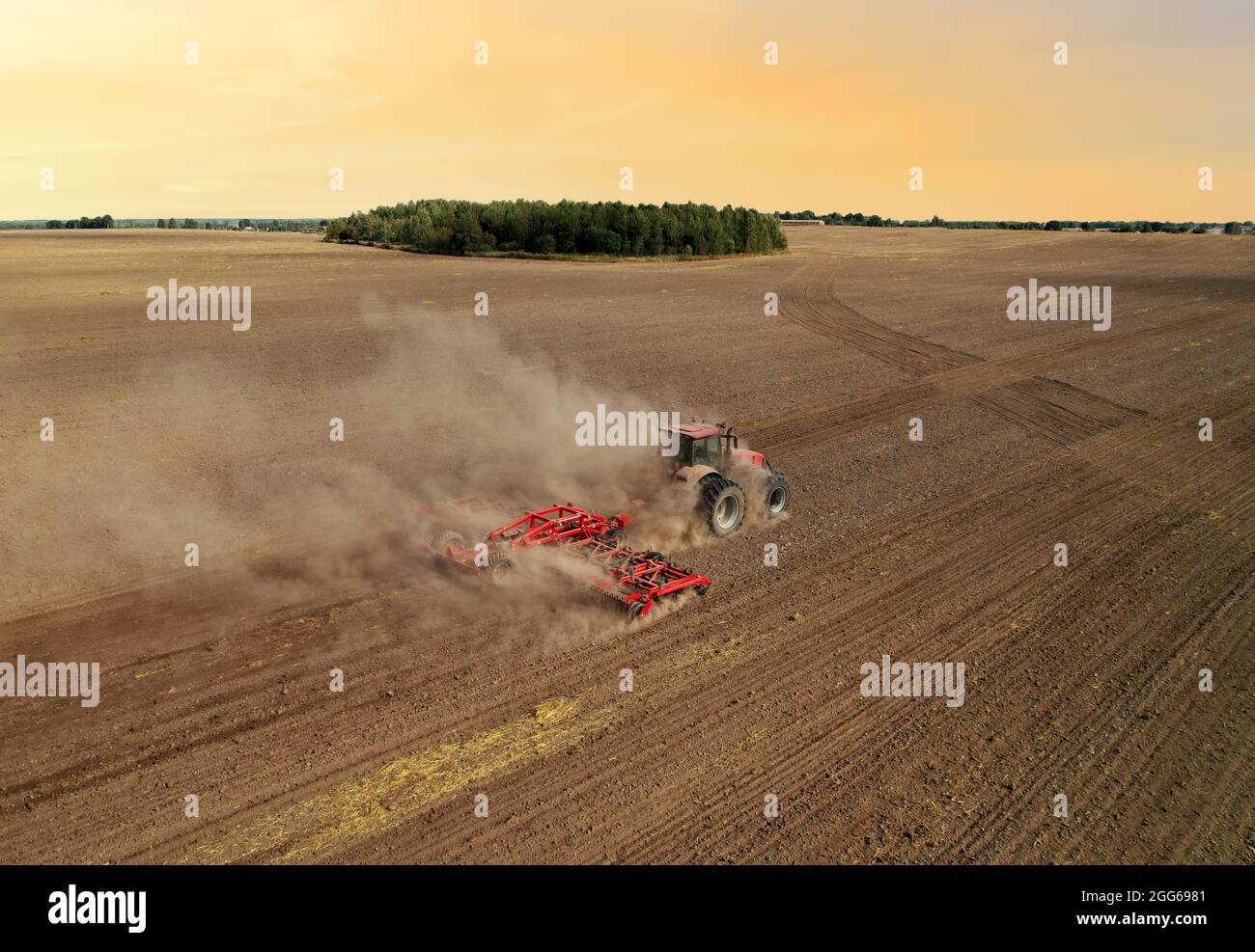 Agricultural tractor on cultivating field for sowing seeds. Farming and ...