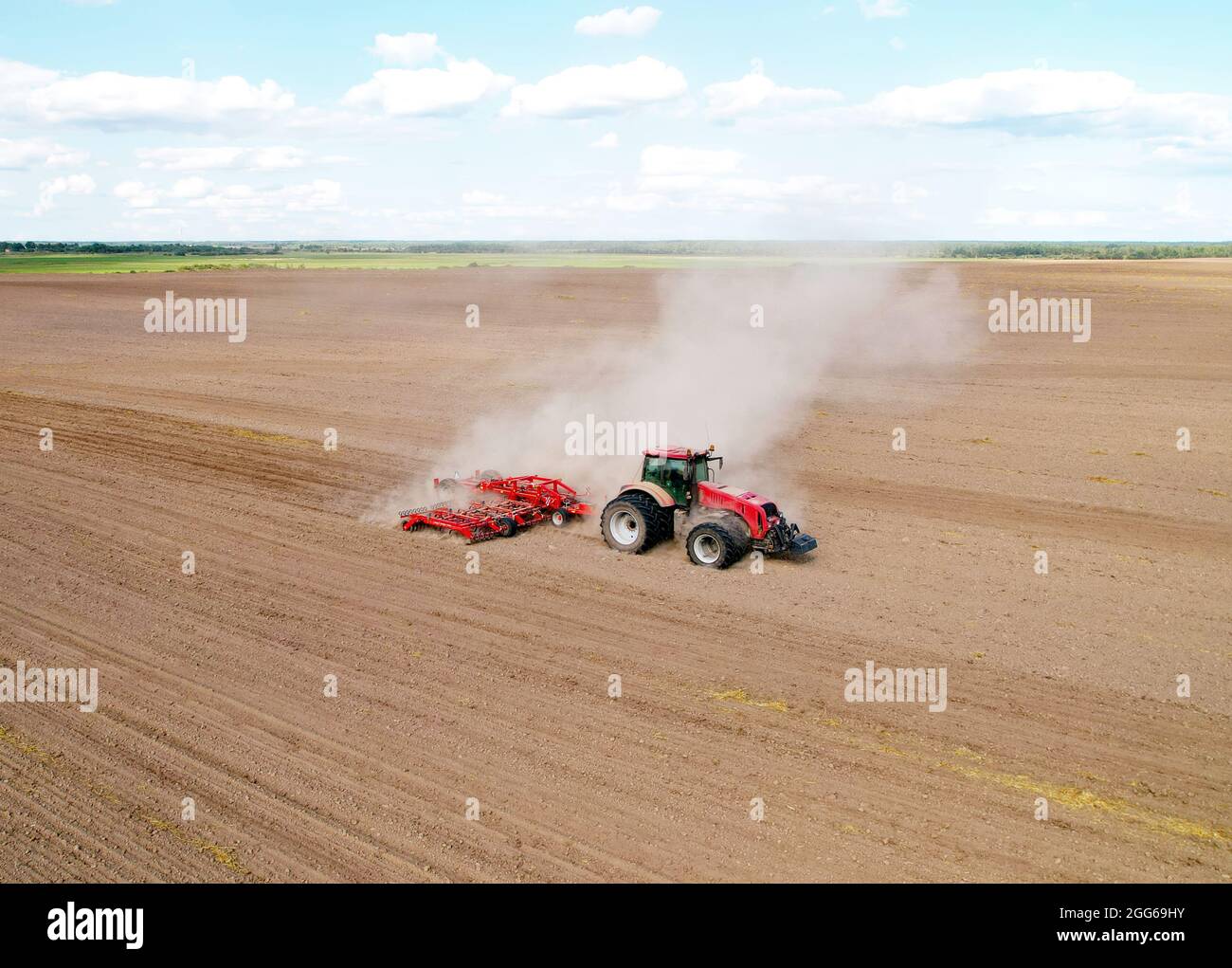 Agricultural tractor on cultivating field for sowing seeds. Farming and ...