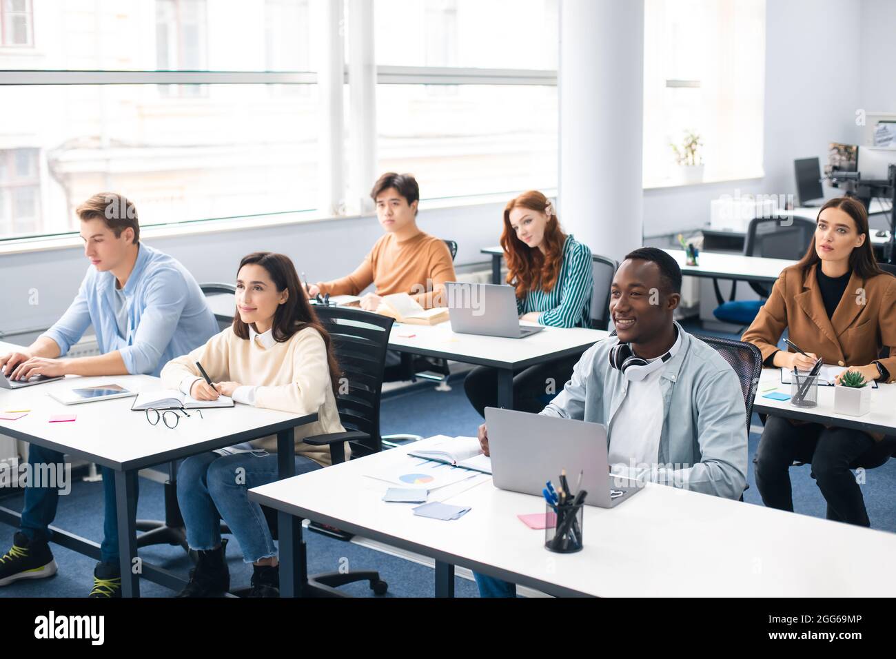 Group of international people listening to teacher at classroom Stock ...