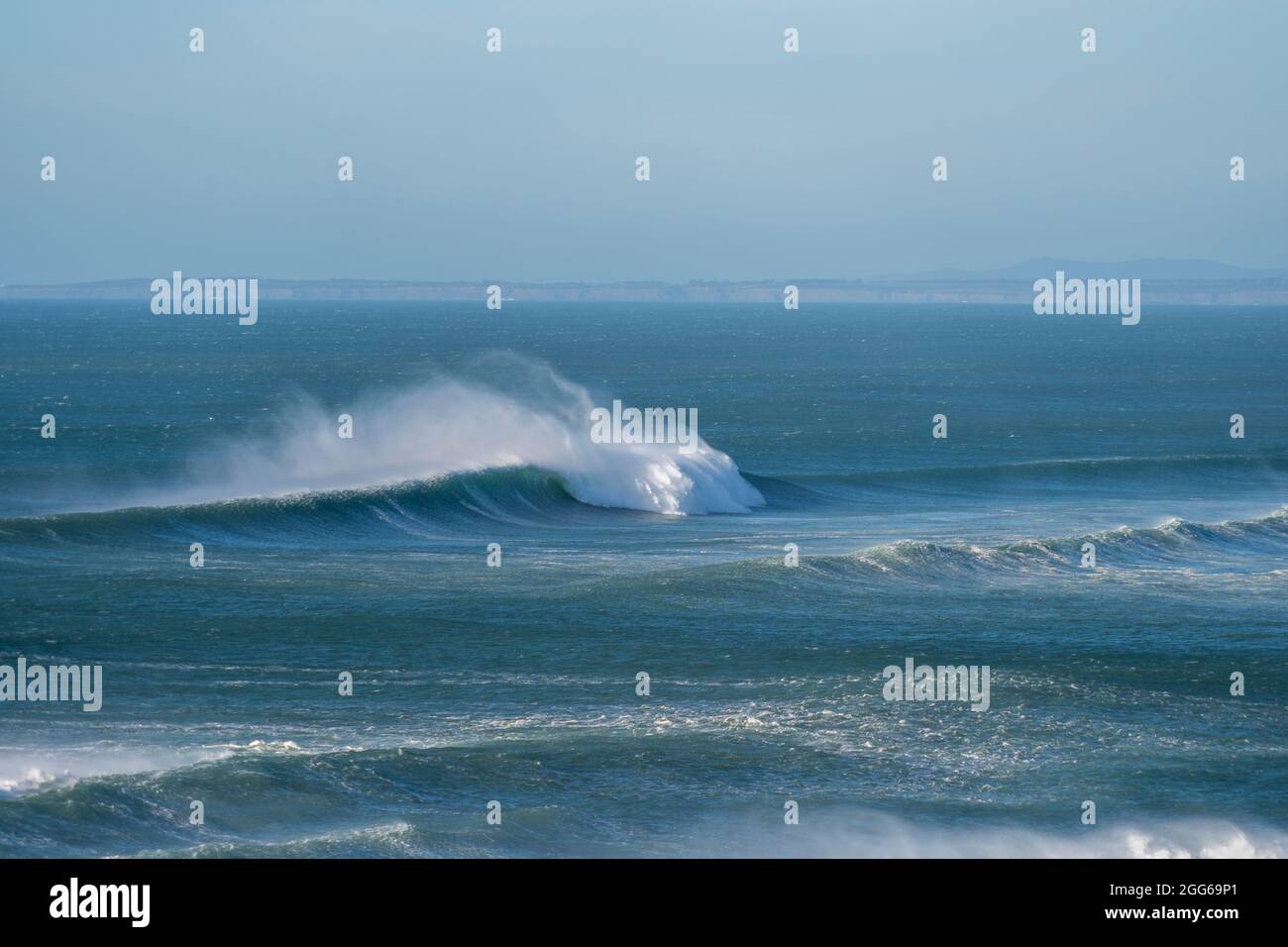 Big wave breaking on a bright sunny morning. Perfect wave barrel with ...