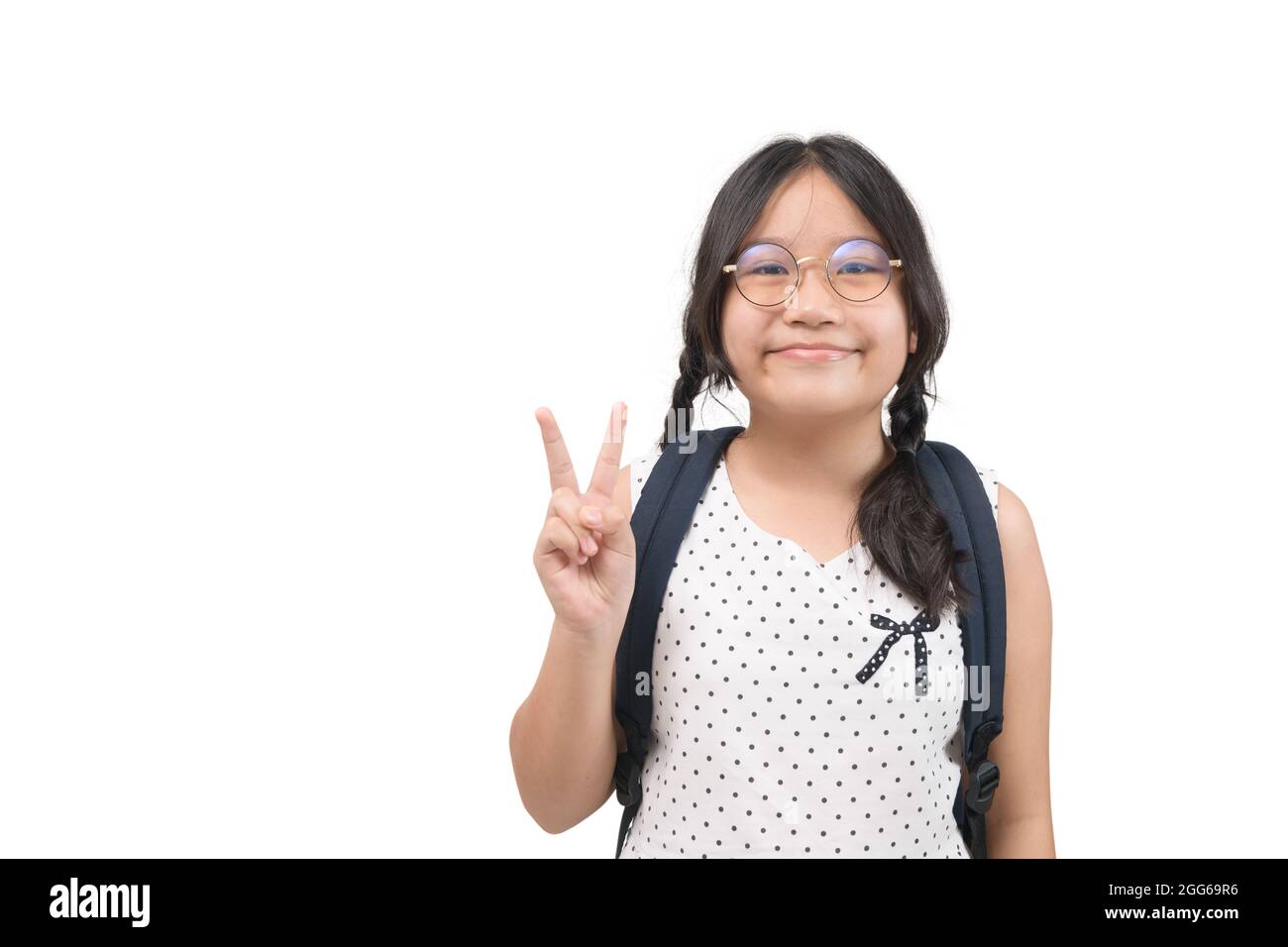 cute girl student smile and shows a victory sign isolated on white ...