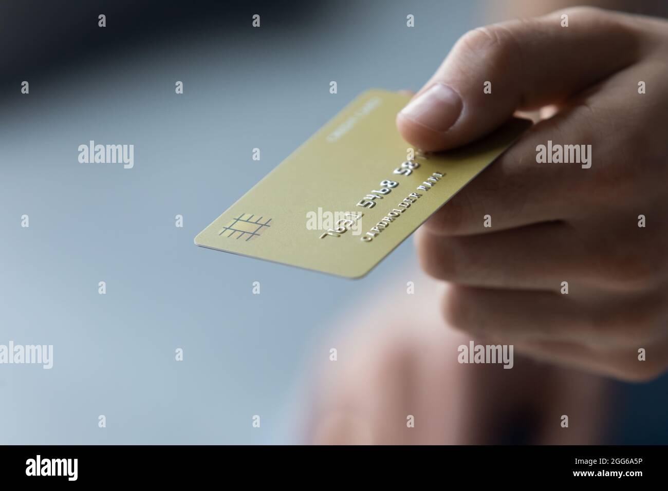 Yellow golden credit card in human hand close up Stock Photo - Alamy