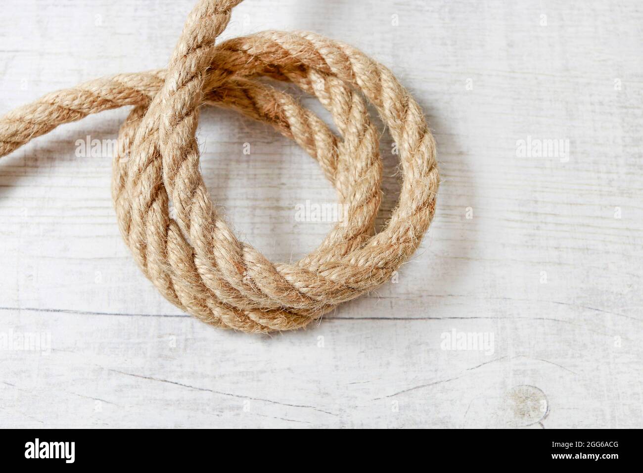 Ship rope isolated on white wooden background Stock Photo - Alamy