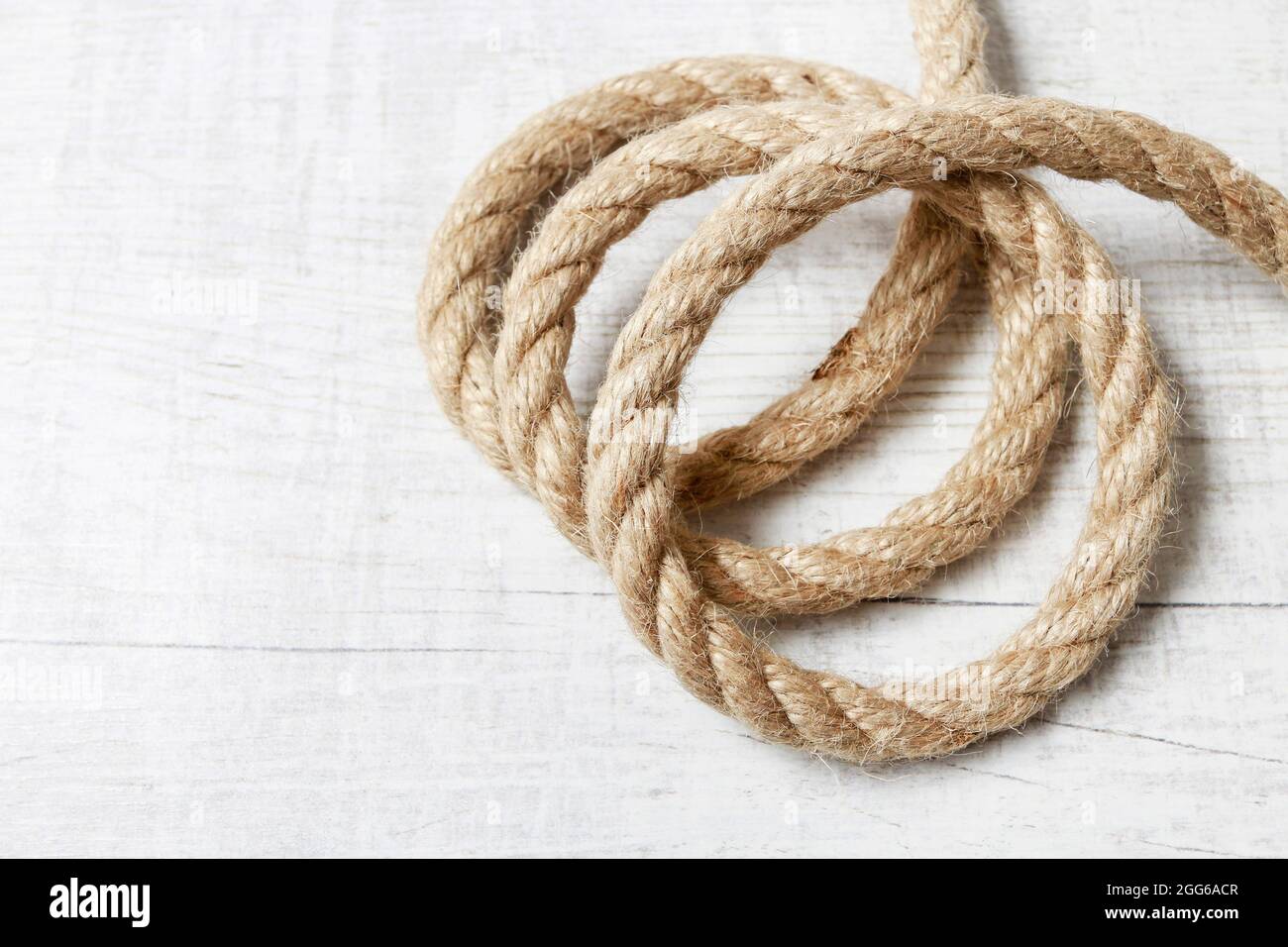 Ship rope isolated on white wooden background Stock Photo - Alamy