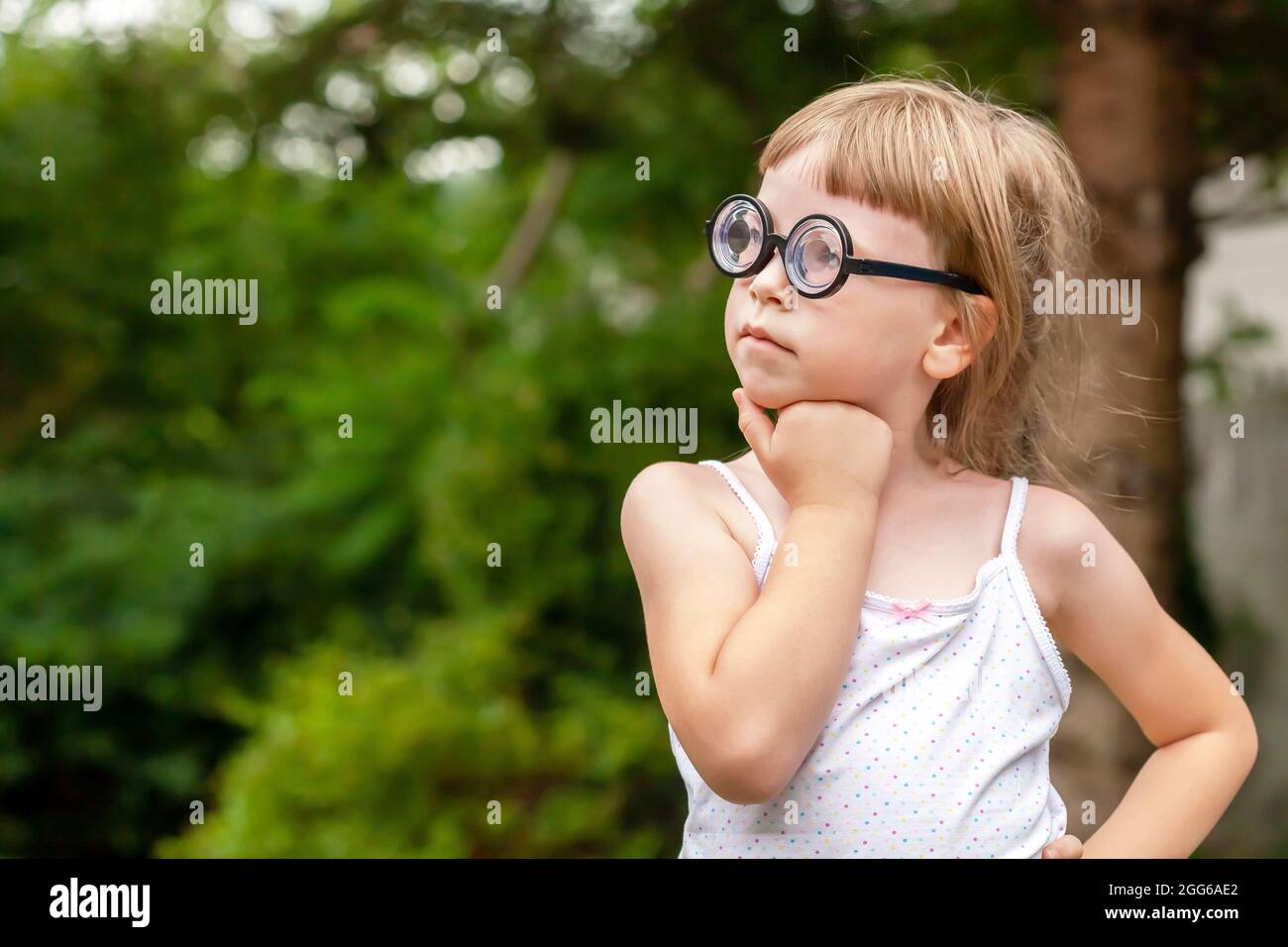 Young clever intelligent school age child, little girl in big quirky ...