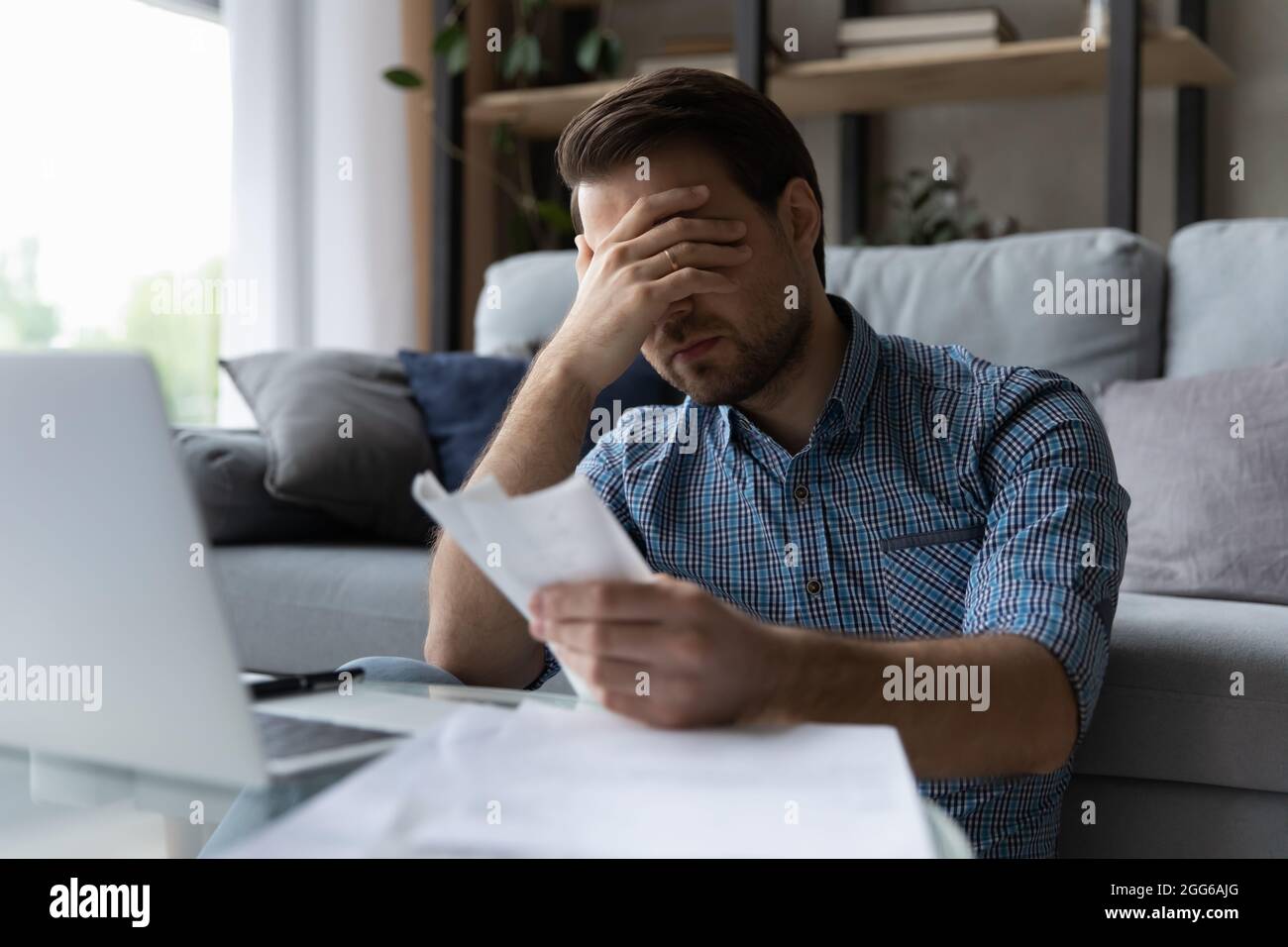 Frustrated desperate millennial man checking bills for payments Stock ...