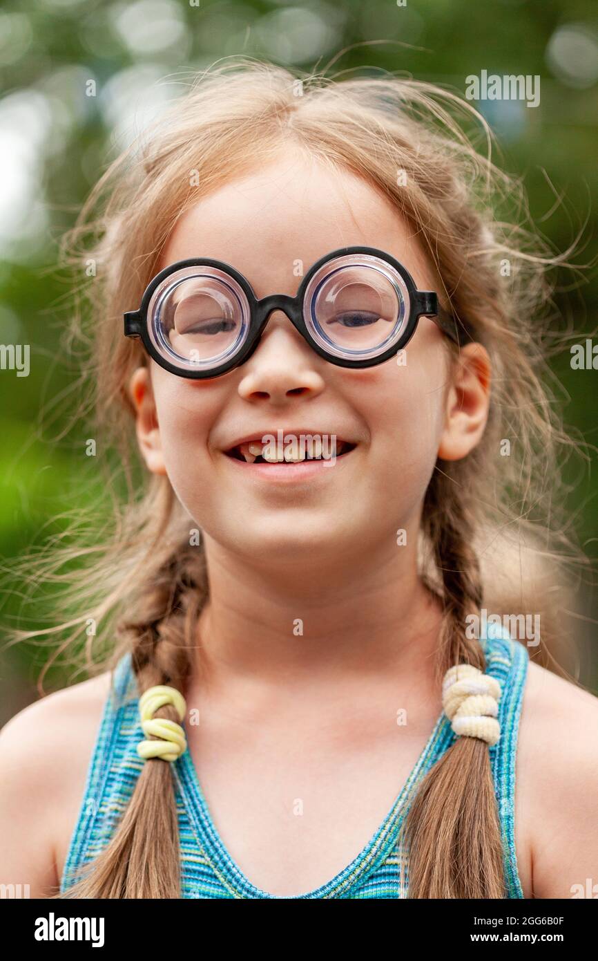 Happy Cheerful Young Little School Age Girl One Single Child In Quirky Funny Big Silly Glasses happy-cheerful-young-little-school-age-girl-one-single-child-in-quirky-funny-big-silly-glasses