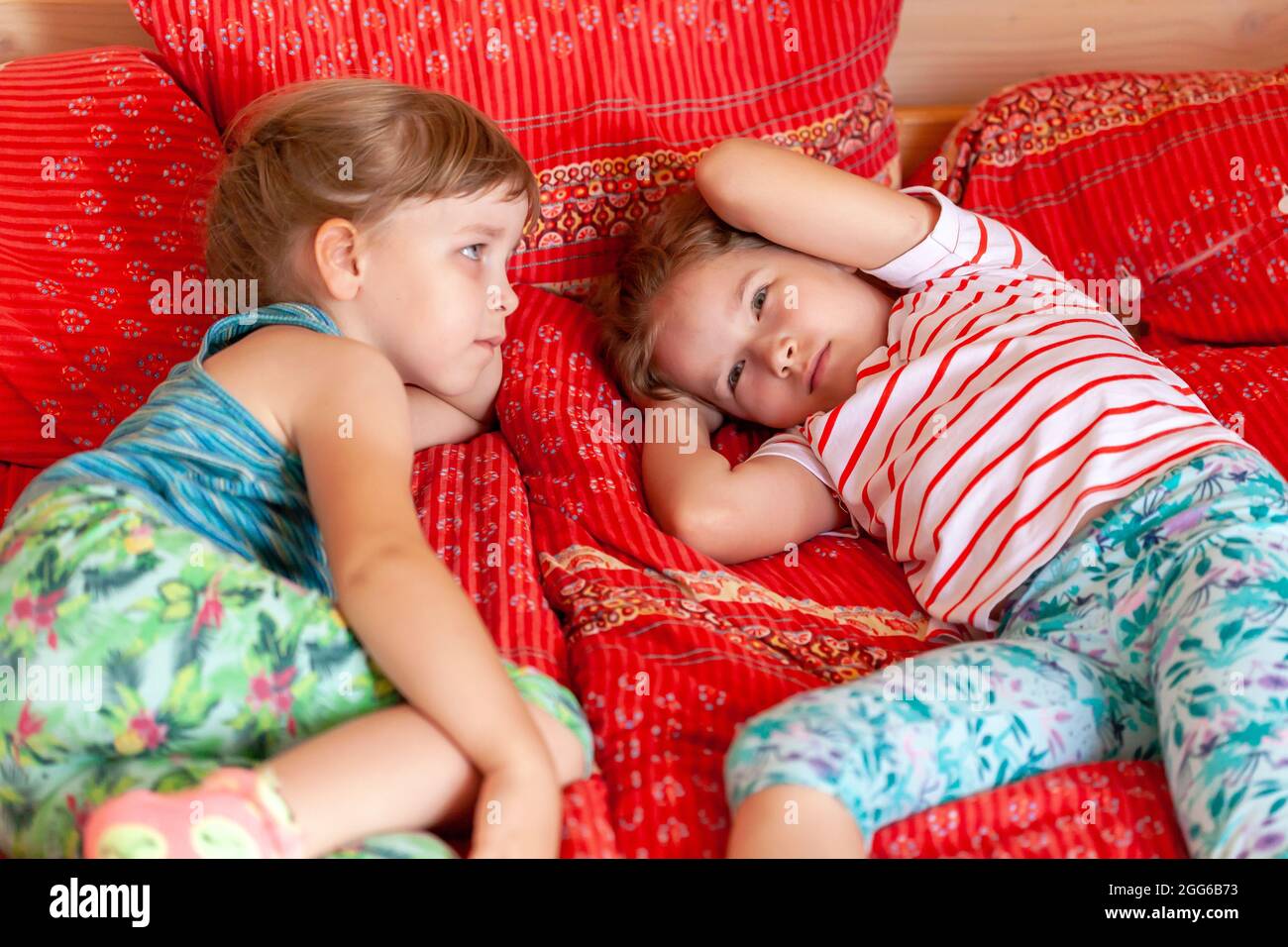 Two little school age girls, healthy young tired exhausted children ...