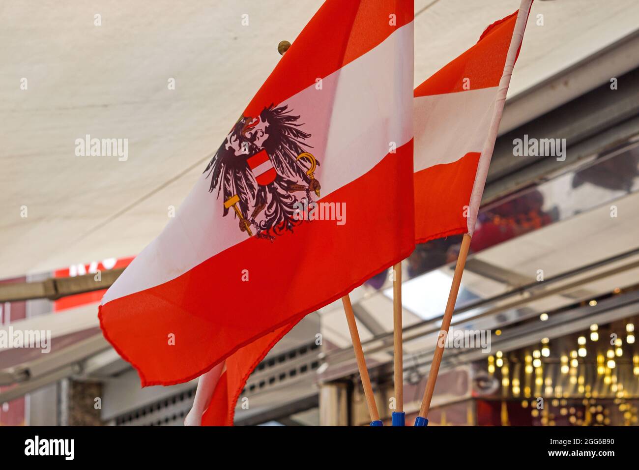 Two Austrian flags with eagles Stock Photo - Alamy