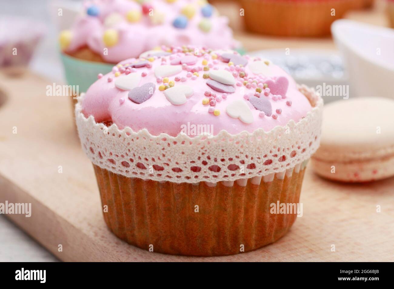 Pink muffins decorated with colorful sprinkles. Party dessert Stock ...