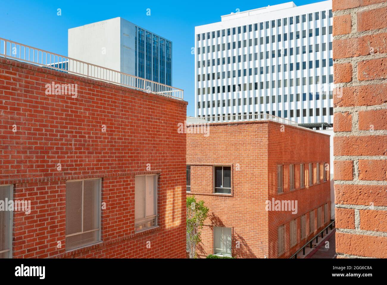 Red and white office and business buildings under clear blue sky in Los ...