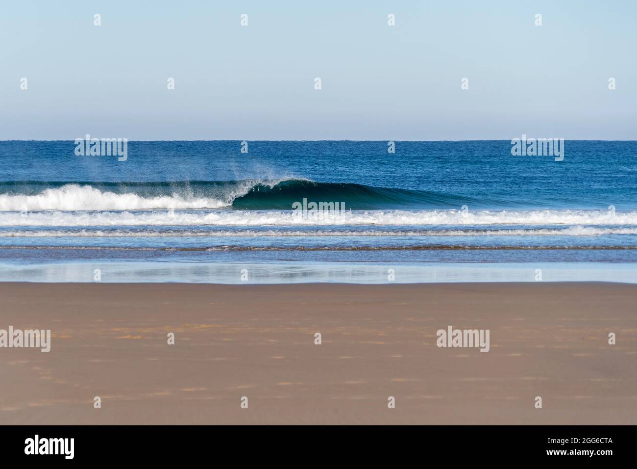 Wave breaking on a bright sunny morning. Perfect wave barrel with ...