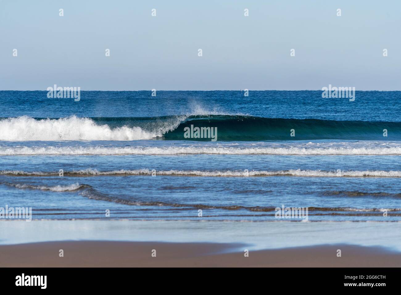 Wave breaking on a bright sunny morning. Perfect wave barrel with ...